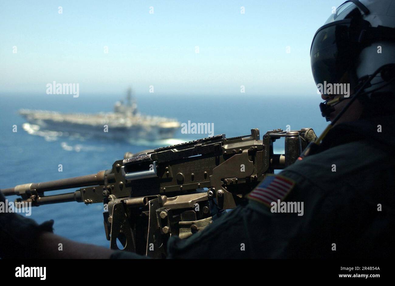 US Navy Aviation Warfare Systems Operator 3rd Class mans a M240D ...