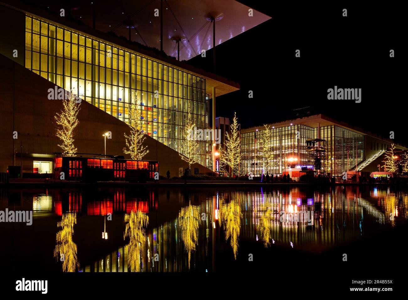 A night scene of a city street illuminated by the soft glow of street ...