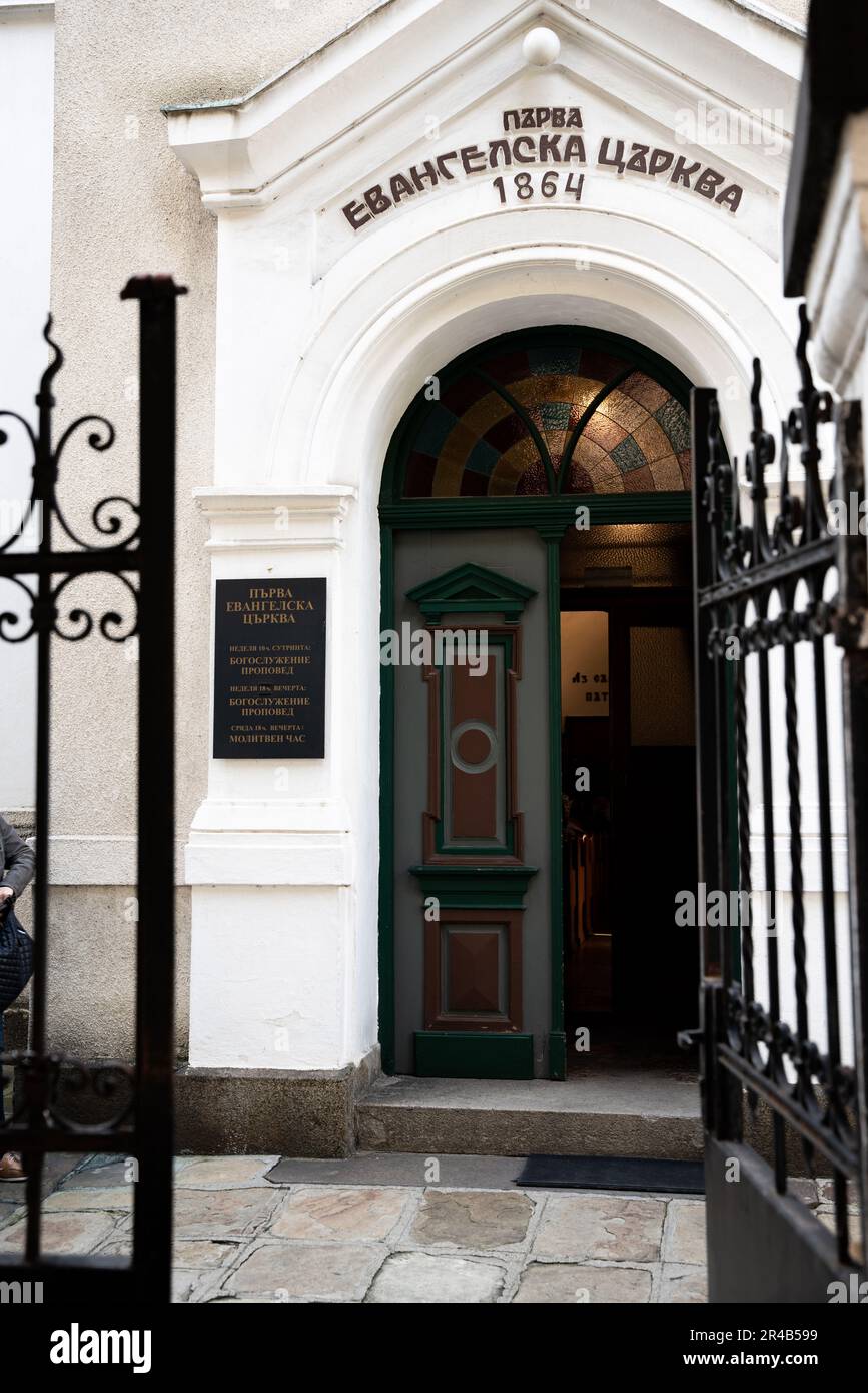 An ornate metal fence surrounds an old door entrance, with a vintage ...