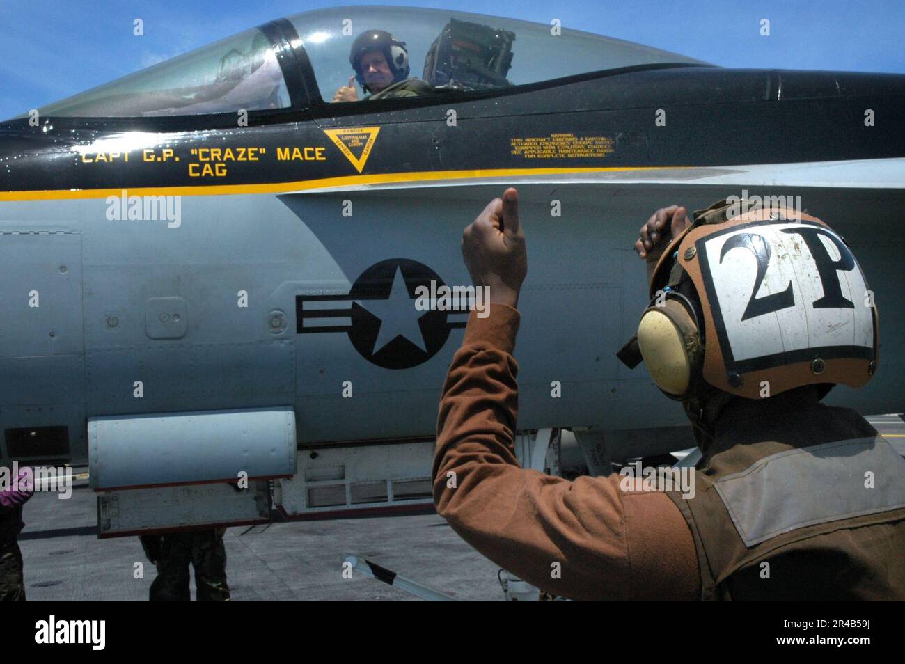 US Navy Capt. signals to a plane captain that his aircraft is ready to ...