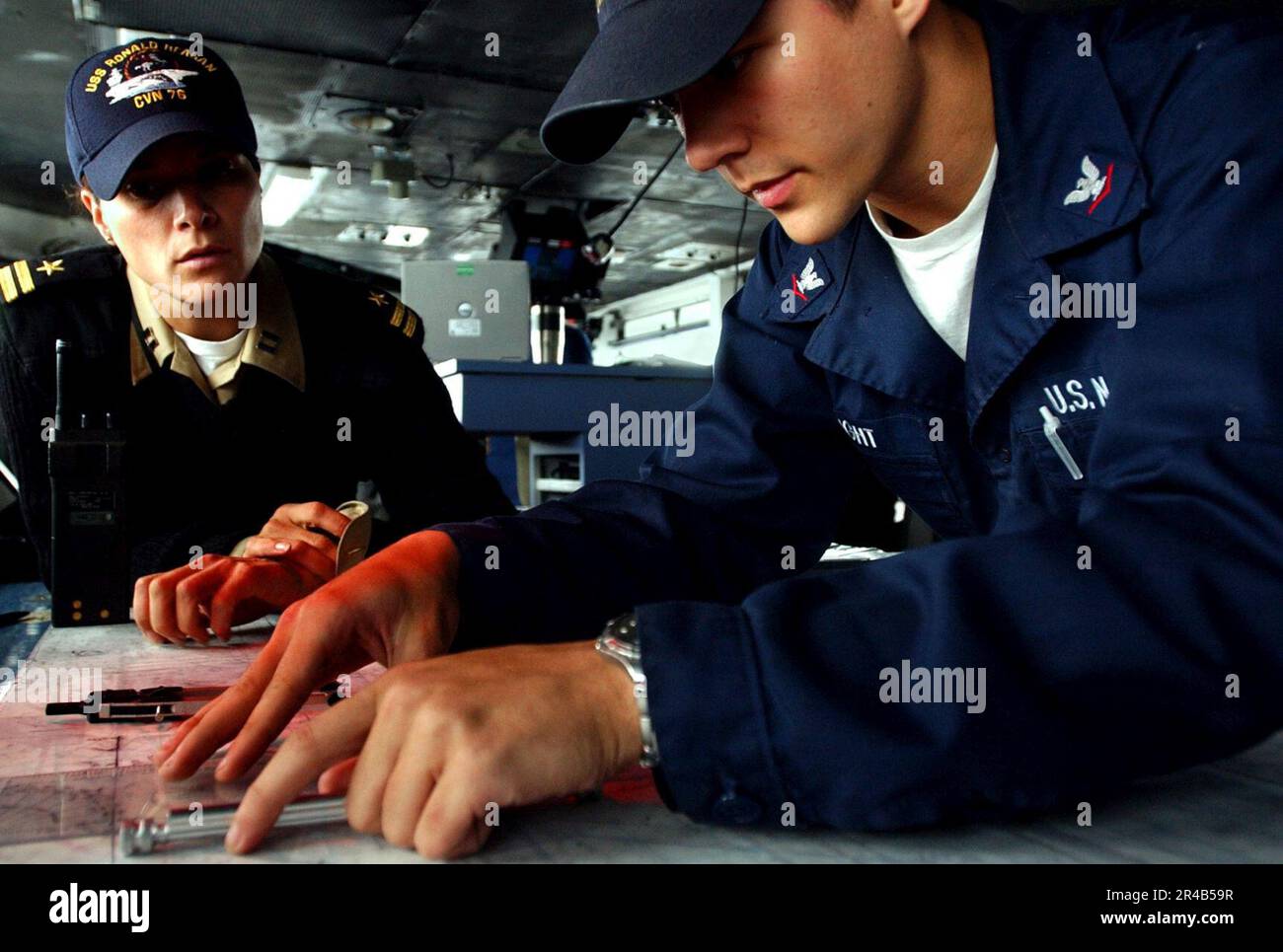 US Navy Quartermaster 3rd Class discuss with the Officer of the Deck ...