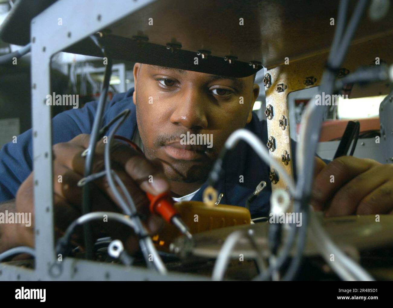 US Navy Aviation Electrician's Mate Airman Apprentice checks resistance ...