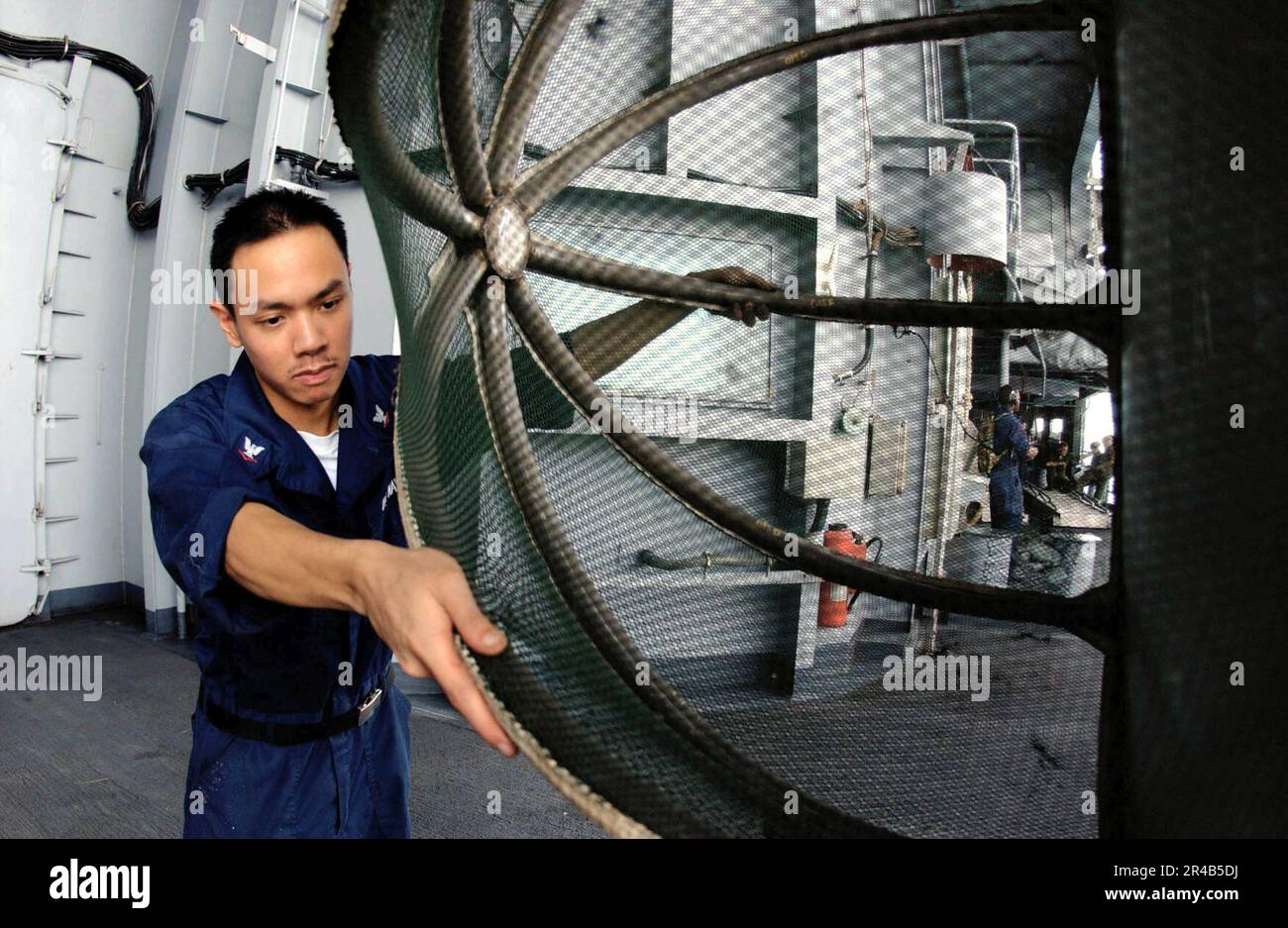 US Navy Aviation Machinist's Mate 3rd Class inspects the cover for an J ...