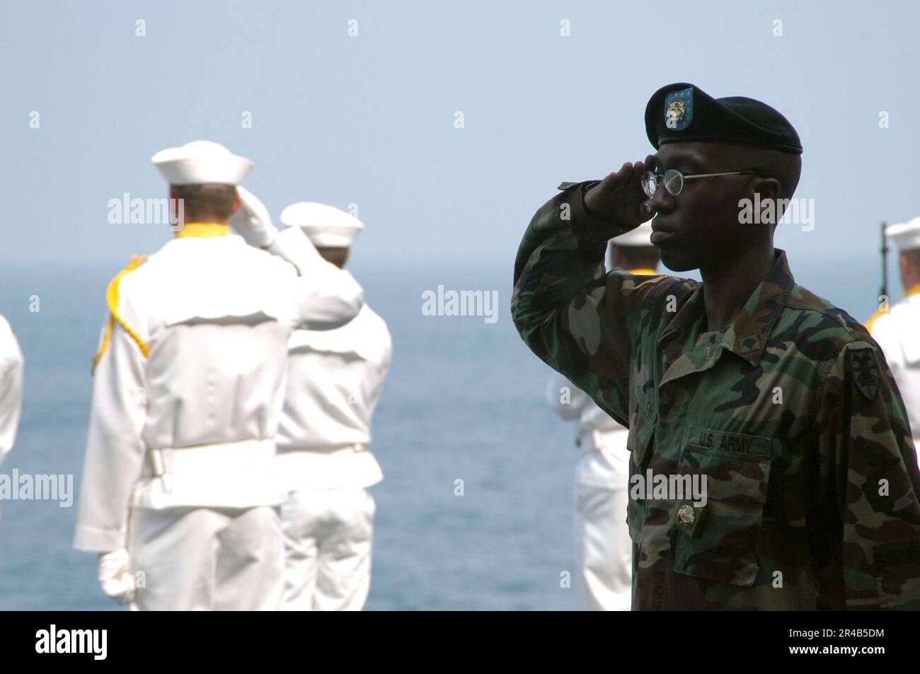 US Navy U.S. Army Spc. salutes during the burial at sea ceremony for ...