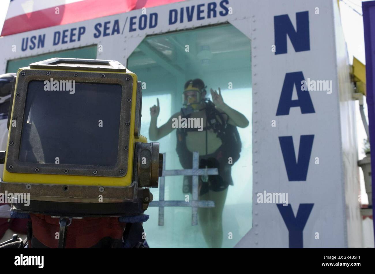 US Navy A U.S. Navy diver flashes hand signals as he teaches Boy Scouts ...