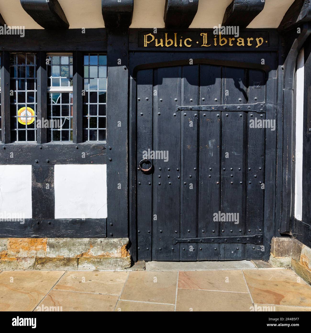Black wooden door in half-timbered house, lettering Public library ...