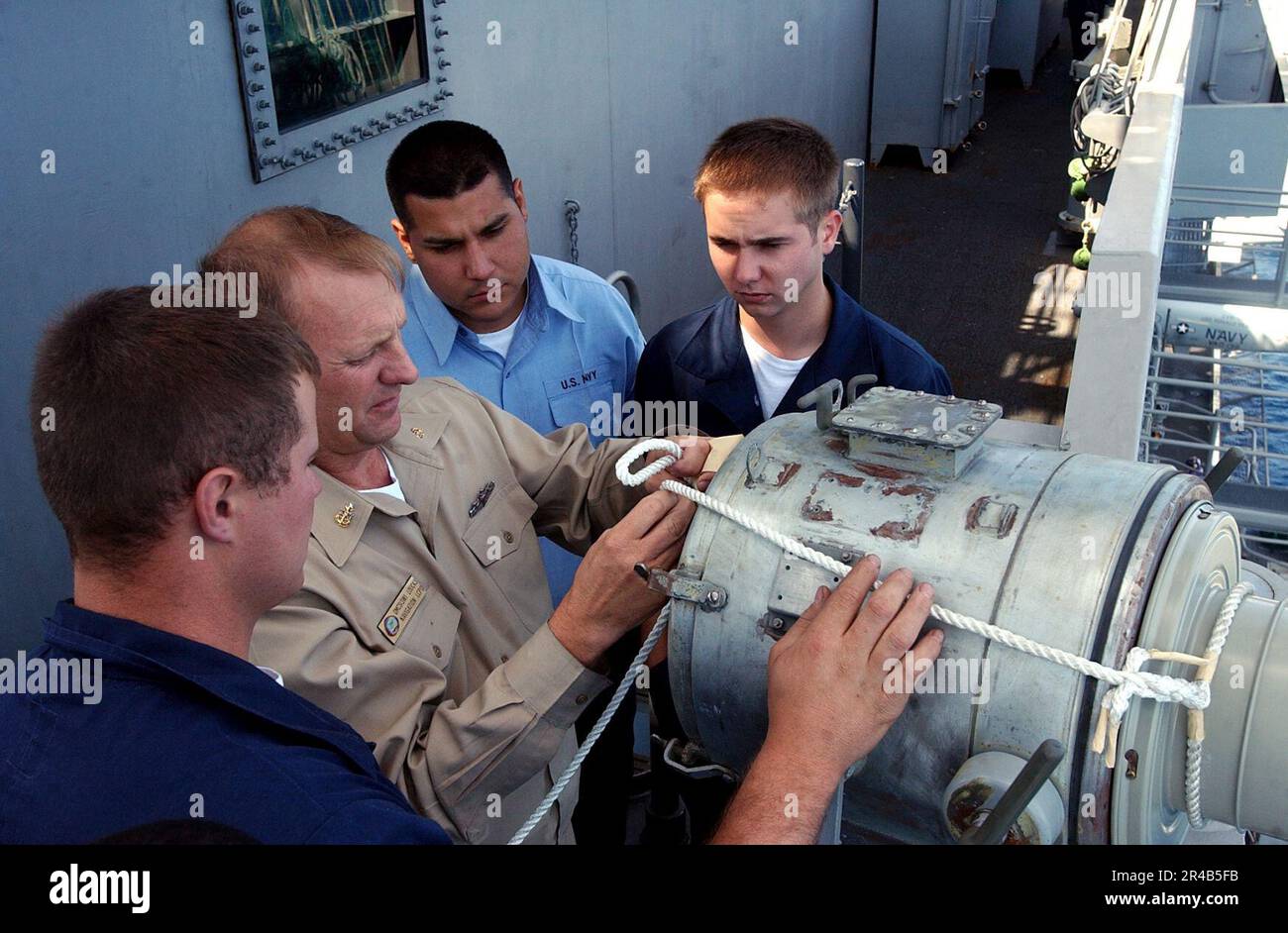 US Navy Senior Chief Quartermaster instructs several Sailors on the ...
