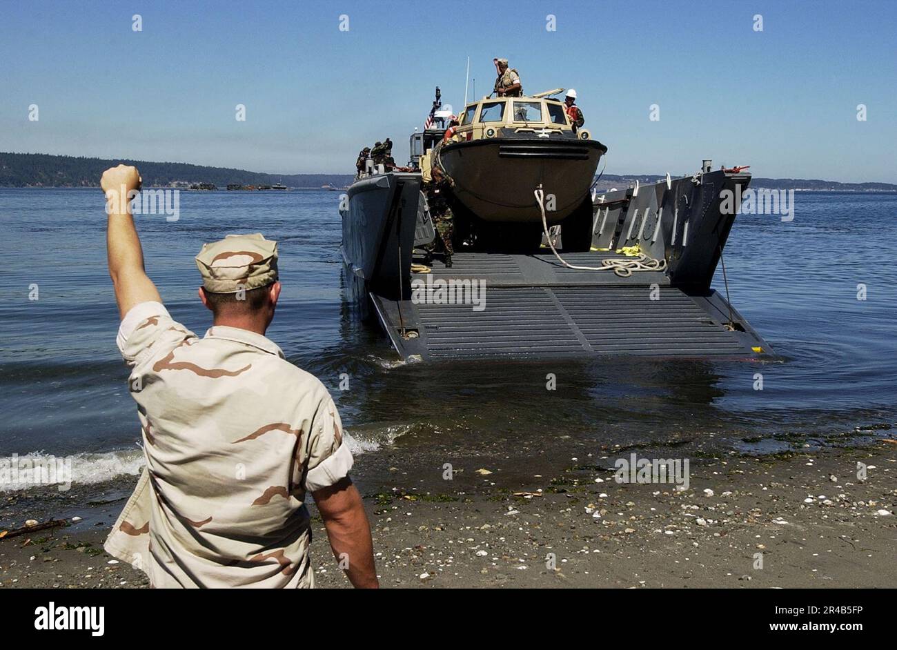 US Navy Sailors assigned to Beachmaster Unit One directs a landing ...