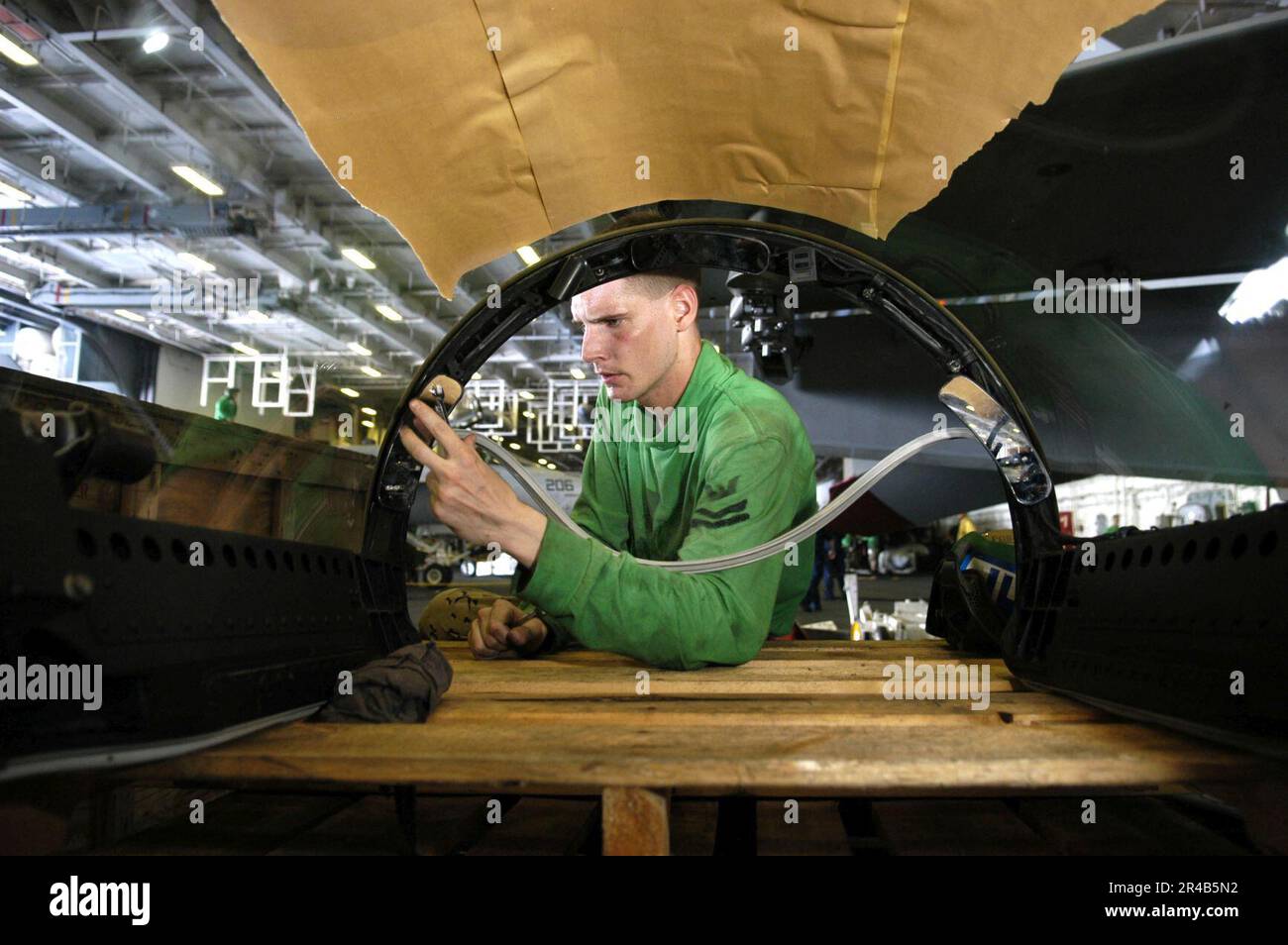 US Navy Aviation Structural Mechanic Equipmentman 2nd Class installs ...