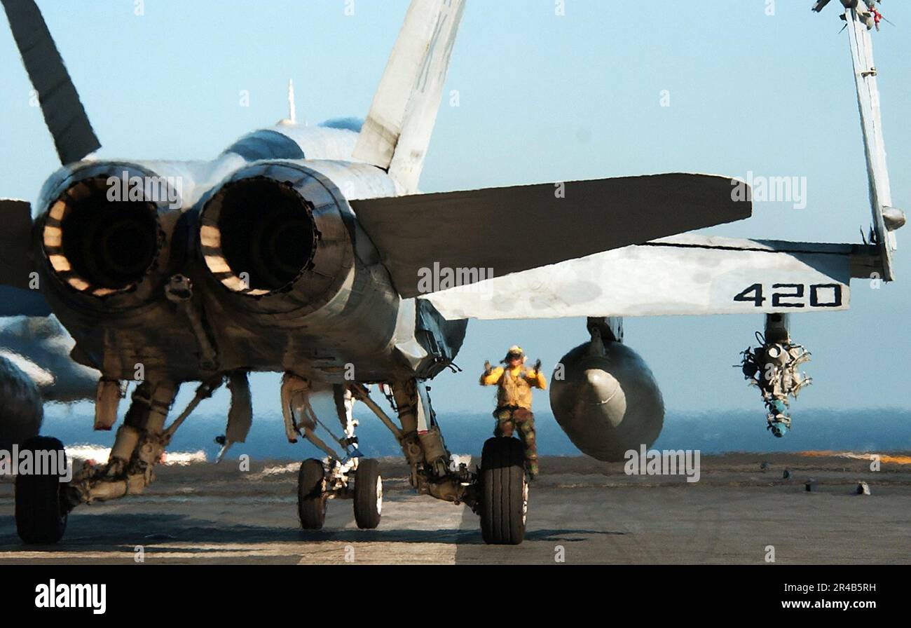 US Navy An aircraft director maneuvers an F-A-18 Hornet on the flight ...