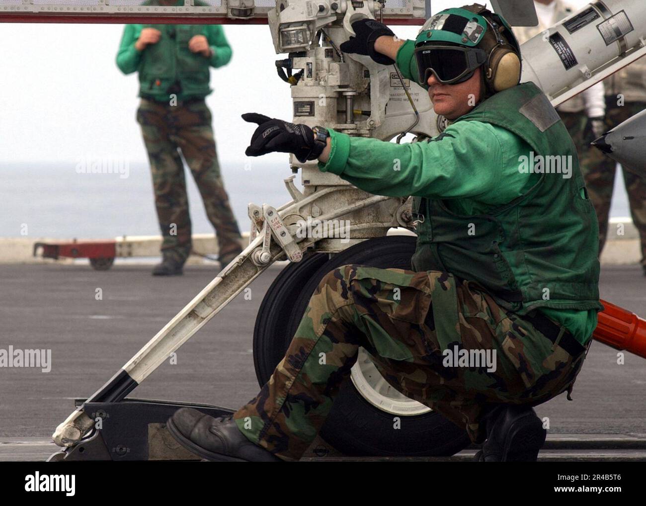 US Navy Aviation Boatswain's Mate 3rd Class signals to the catapult ...