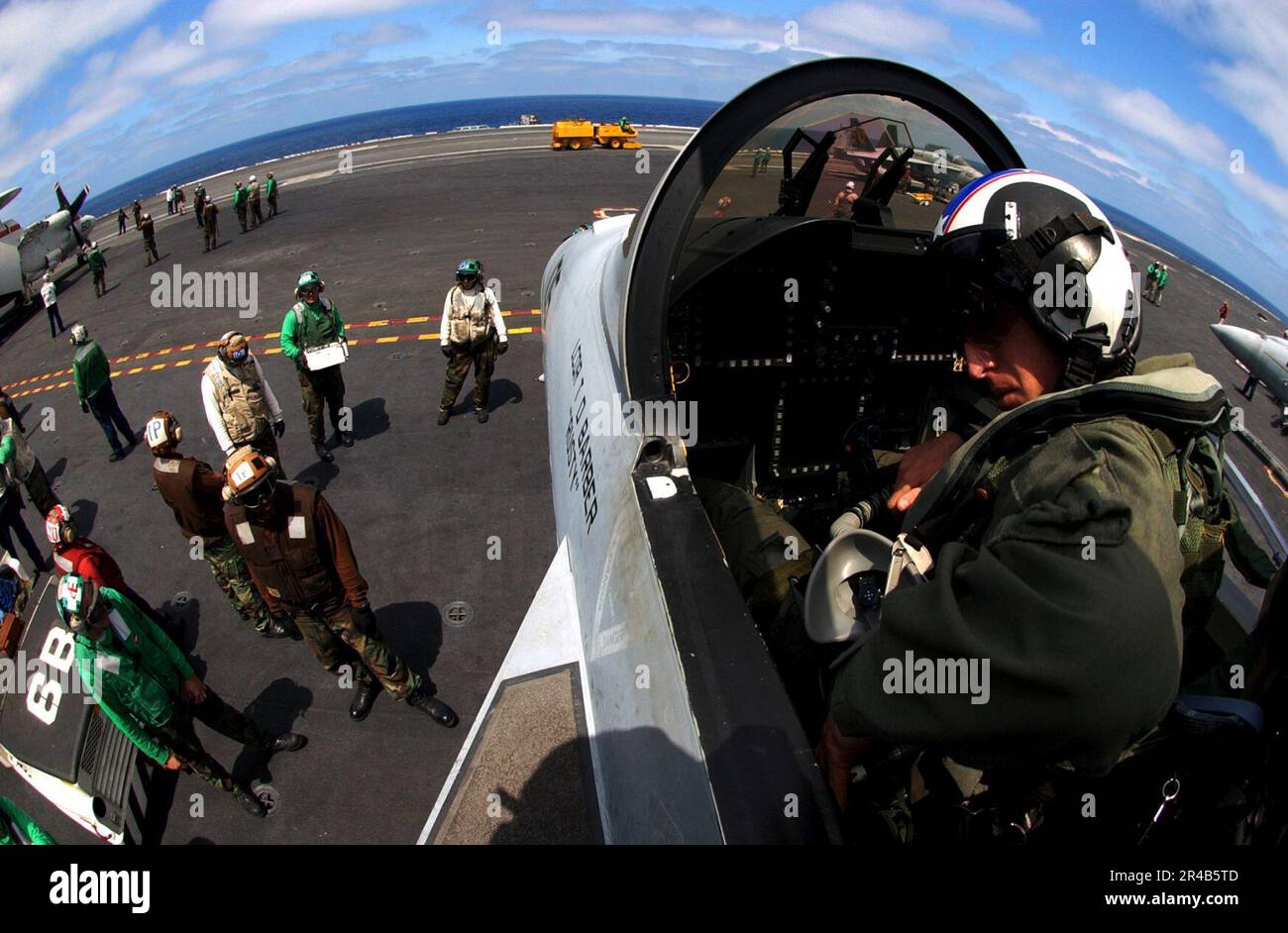 US Navy A pilot secures himself into an F-A-18E Super Hornet prior to ...