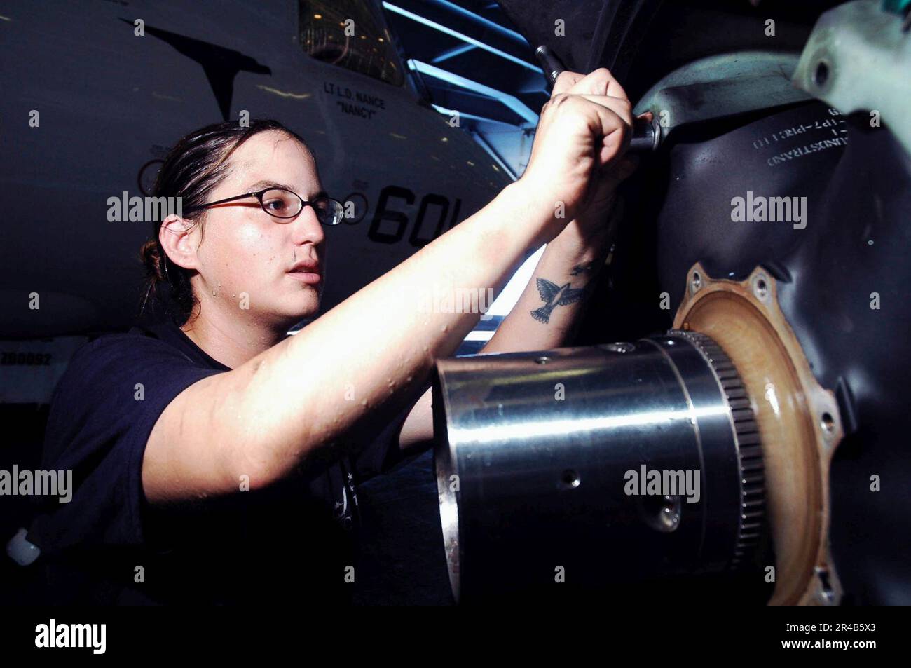 US Navy Aviation Machinist's Mate 3rd Class removes the rear spinner ...