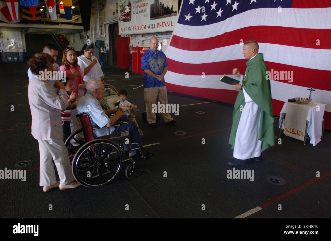 US Navy USS Peleliu (LHA 5) Chaplain, Lt. Cmdr. performs a baptism ...