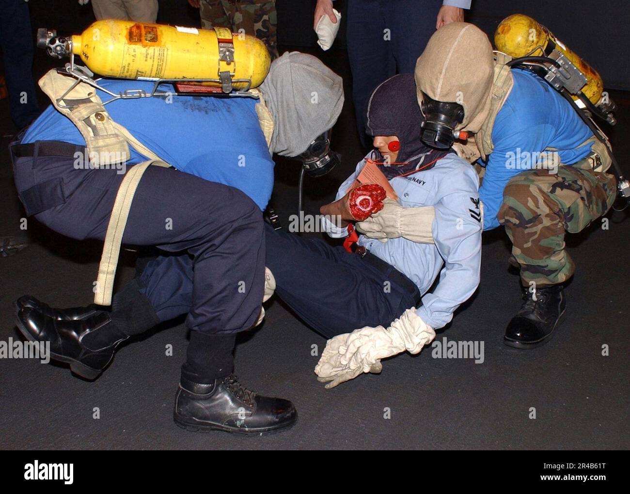 US Navy Airmen execute a two man carry, while transporting a simulated ...