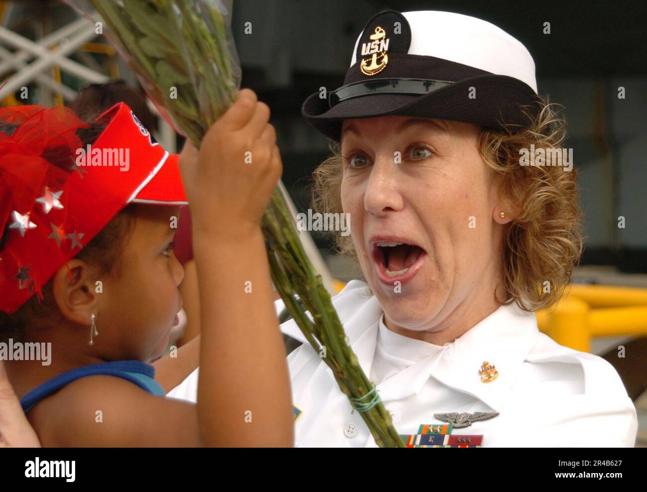 US Navy Chief Master at Arms embraces her daughter, at pier 14 on board ...