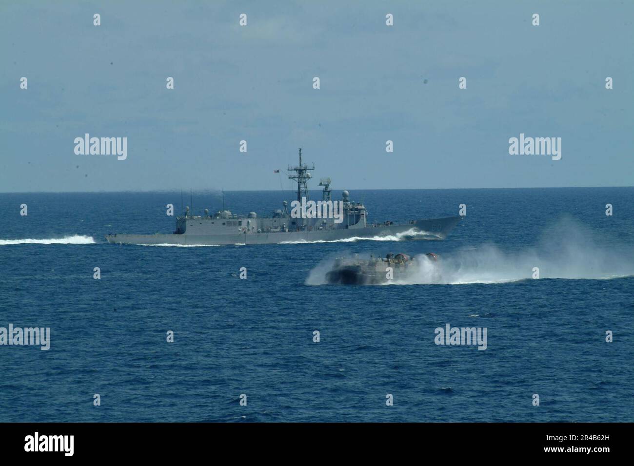 US Navy A landing craft air cushion (LCAC) passes by the guided missile ...