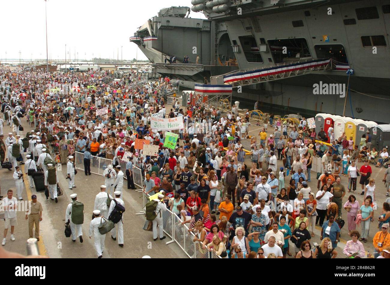 US Navy Large crowd waits for crew members to leave the ship Stock ...