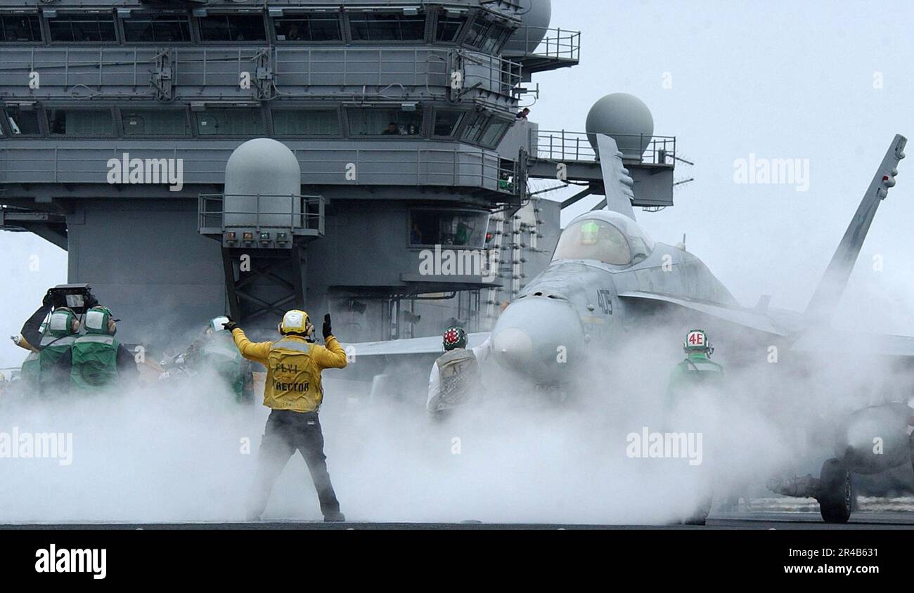 US Navy An aircraft handler signals an F-A-18C Hornet, assigned to the ...