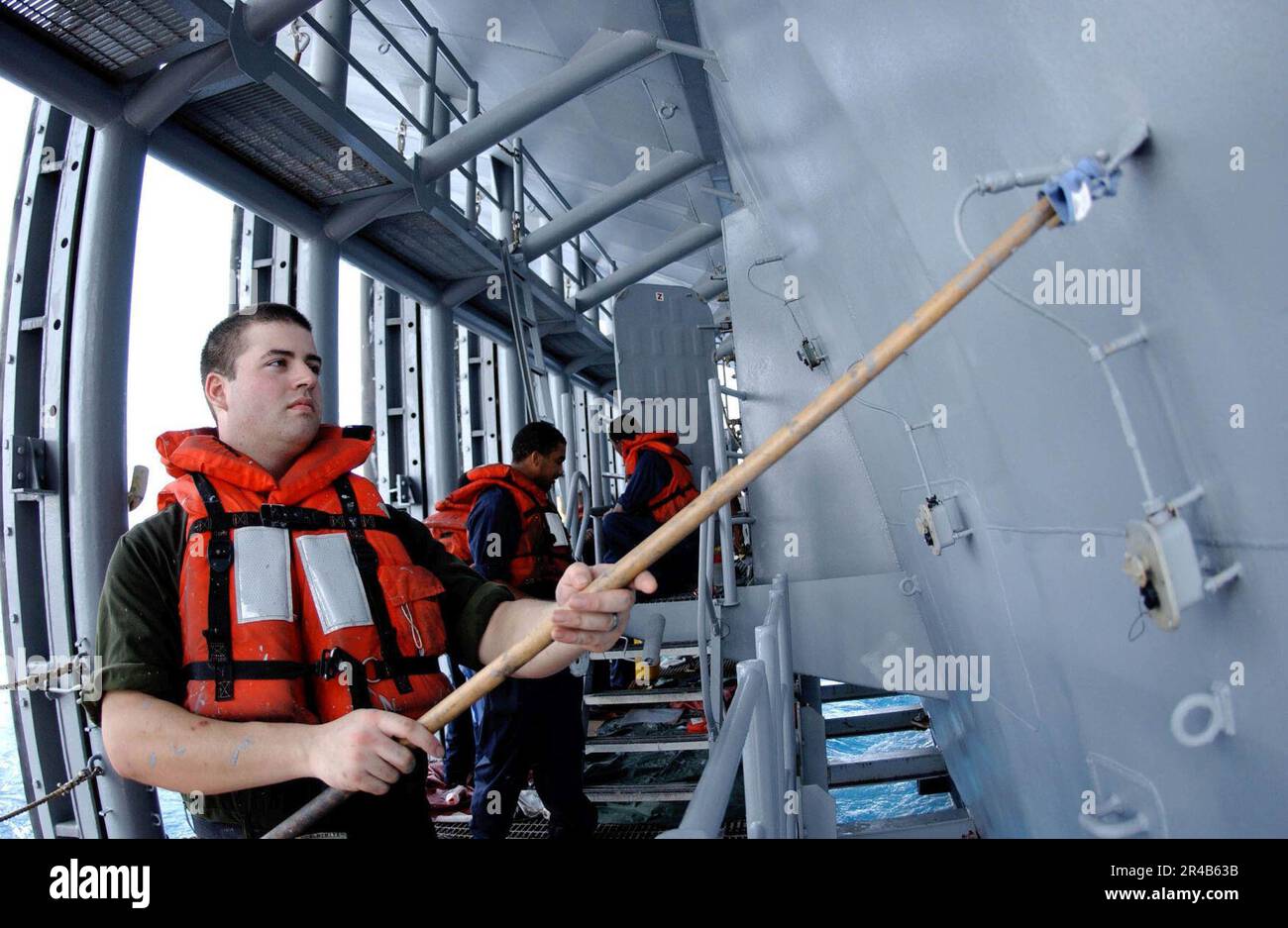 US Navy Seaman paints the stern dock aboard the nuclear-powered ...
