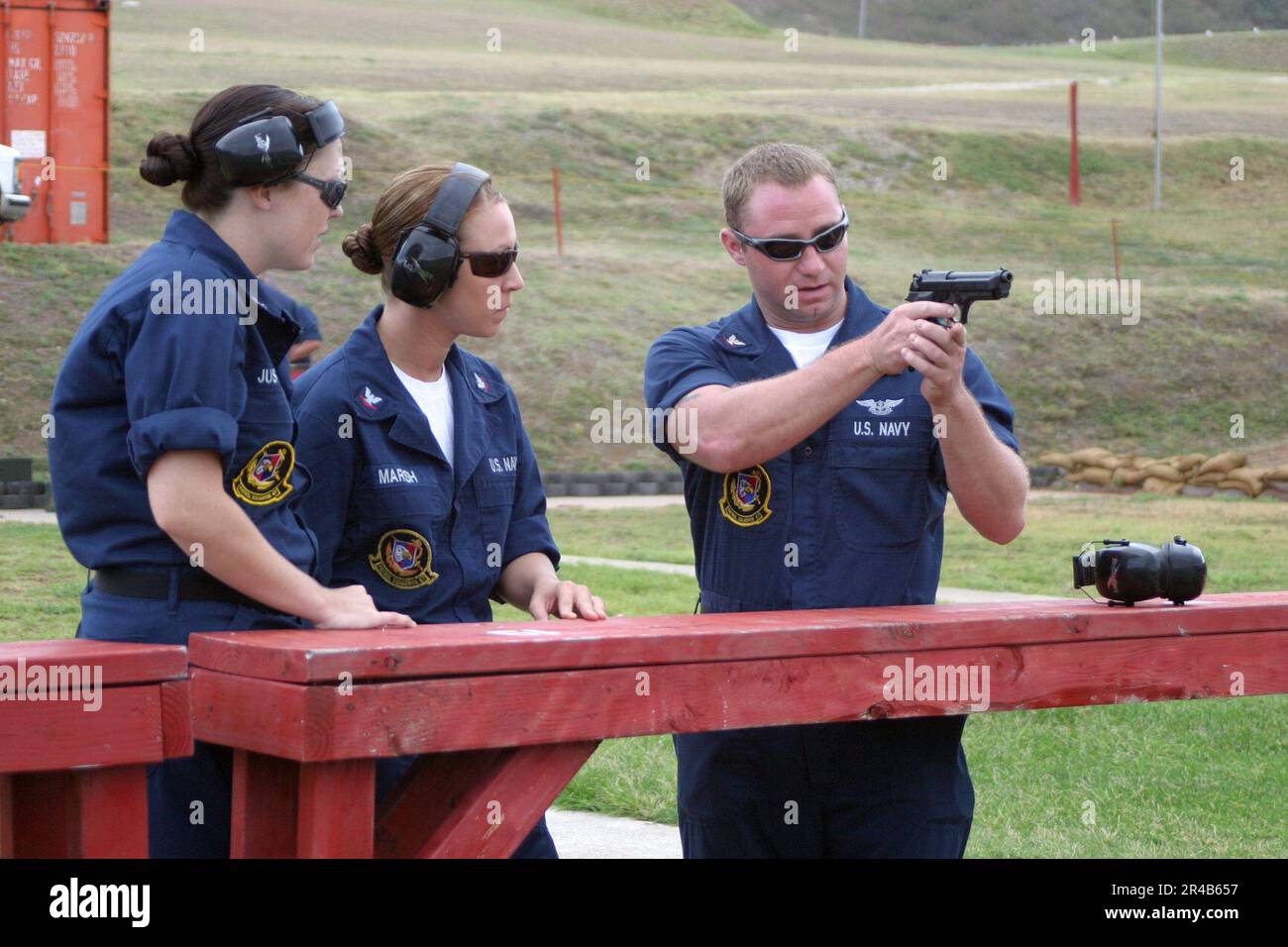 US Navy Aviation Ordnanceman 3rd Class right, instructs Aviation ...