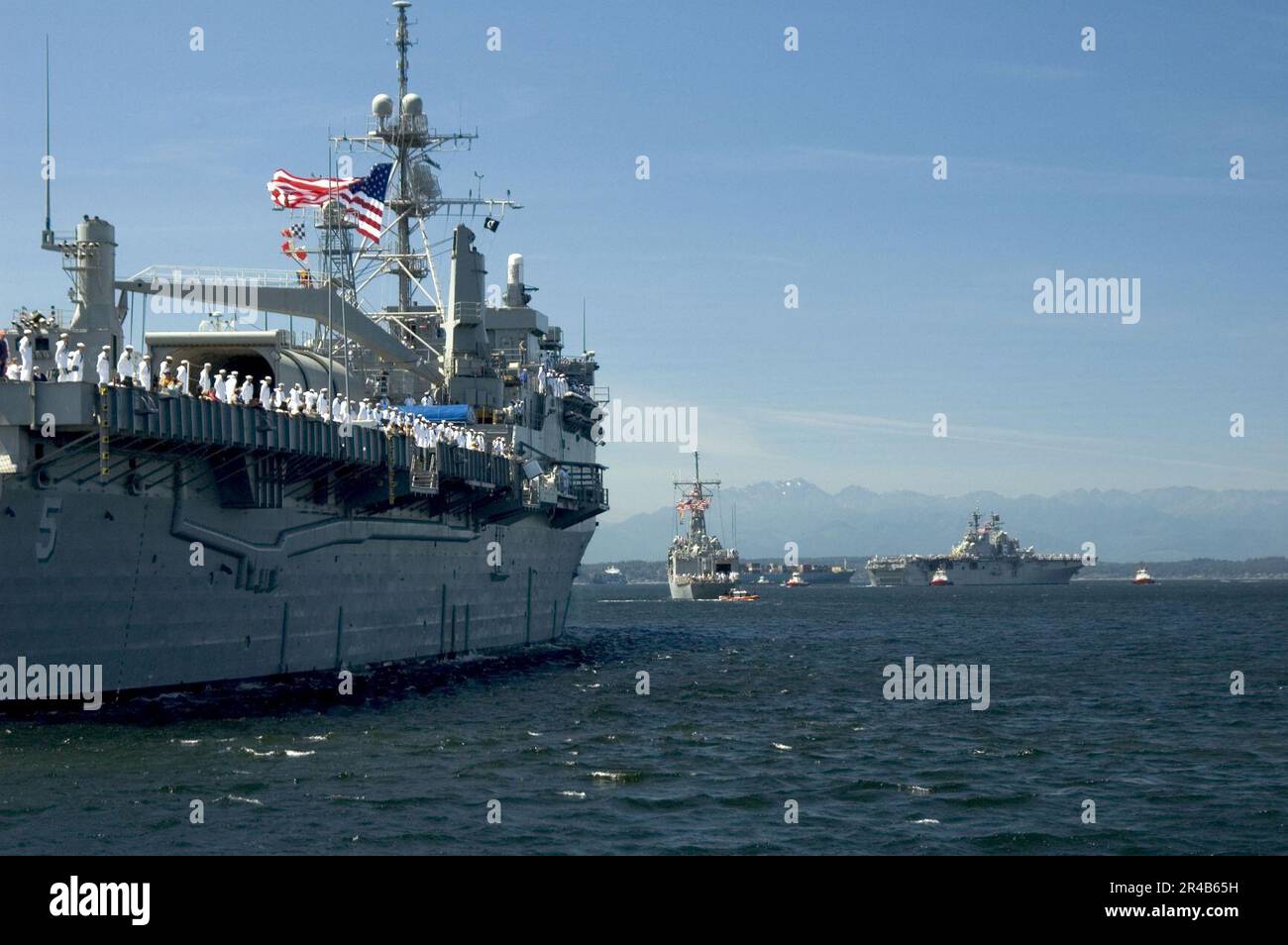 US Navy The amphibious transport dock USS Ogden (LPD 5), left, guided ...