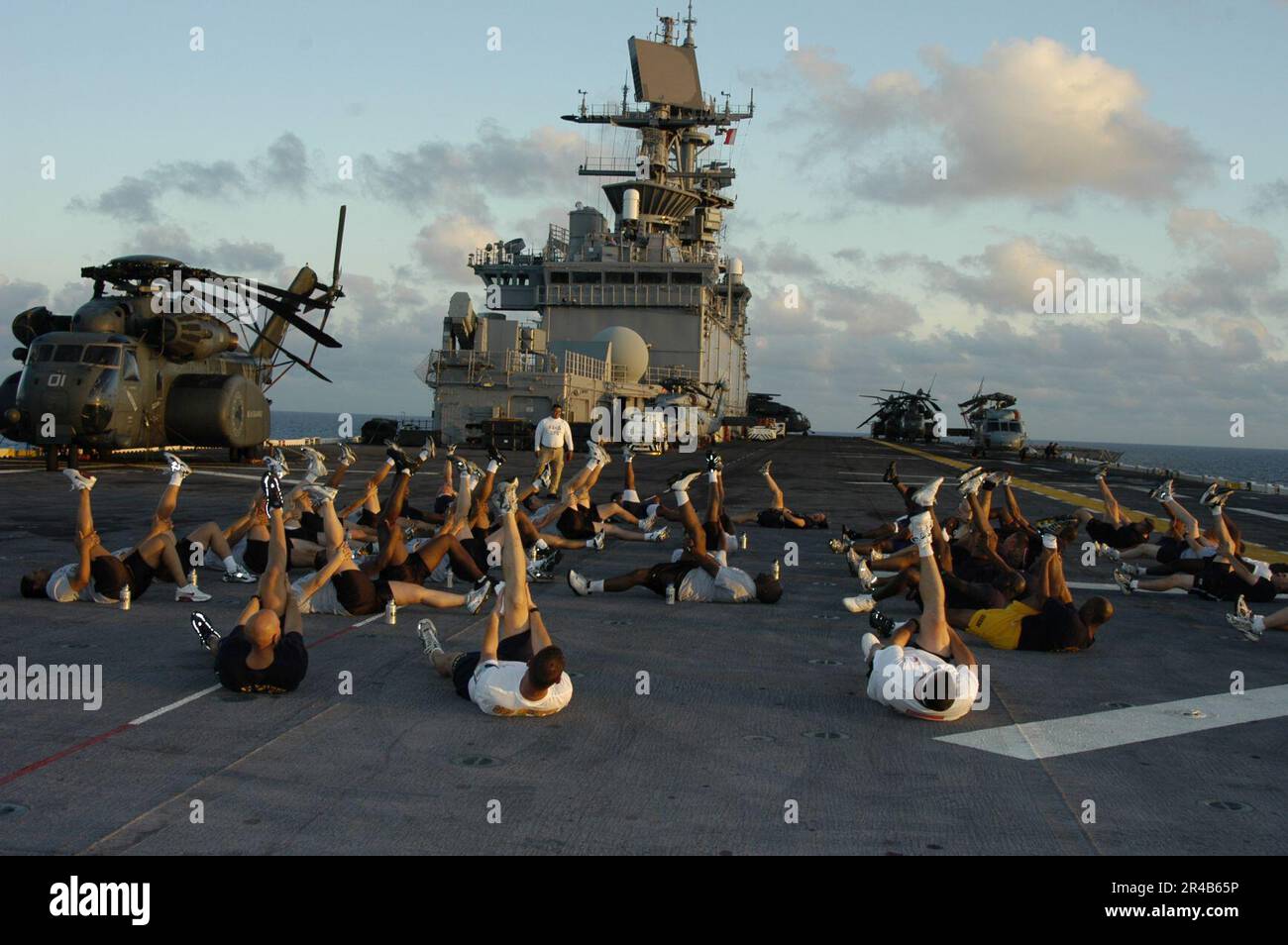 US Navy Chief petty officer (CPO) selectees stretch prior to conducting ...