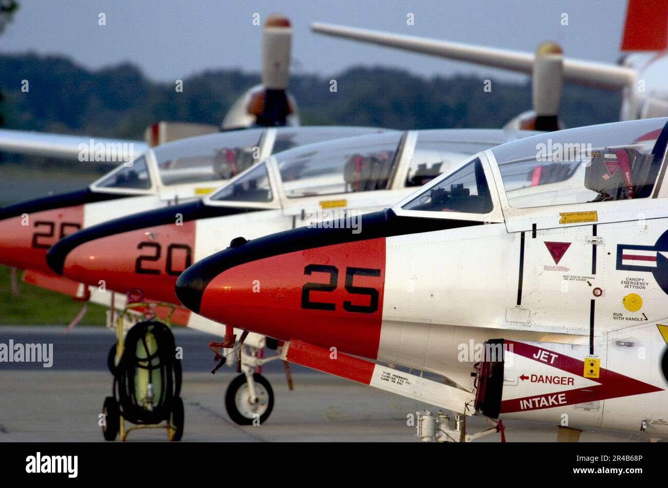 US Navy T-2C Buckeye aircraft line the flight line during sunset at the ...