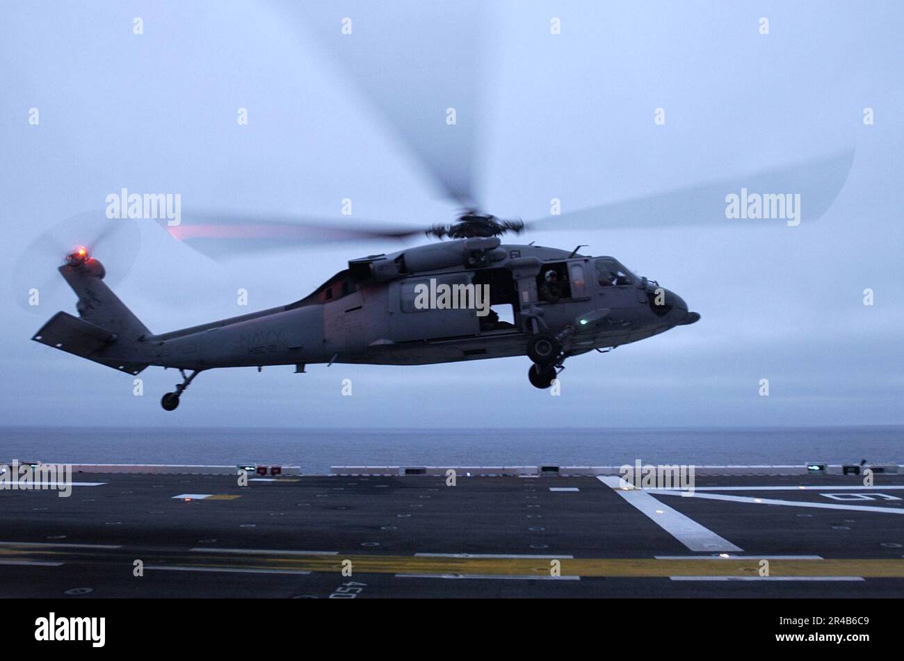 US Navy An MH-60S Seahawk akes off from the flight deck of the ...