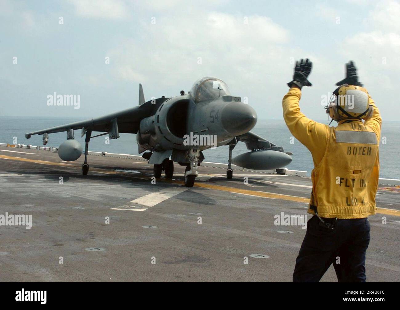 US Navy An Aviation Boatswains Mate directs an AV-8B Harrier, assigned ...