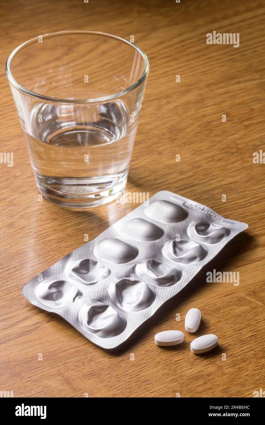 Medicines with a glass of water, tablets, blister pack Stock Photo - Alamy
