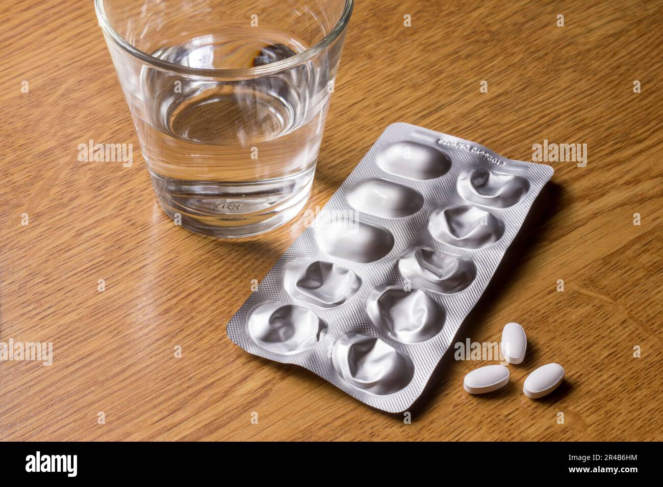Medicines with a glass of water, tablets, blister pack Stock Photo - Alamy