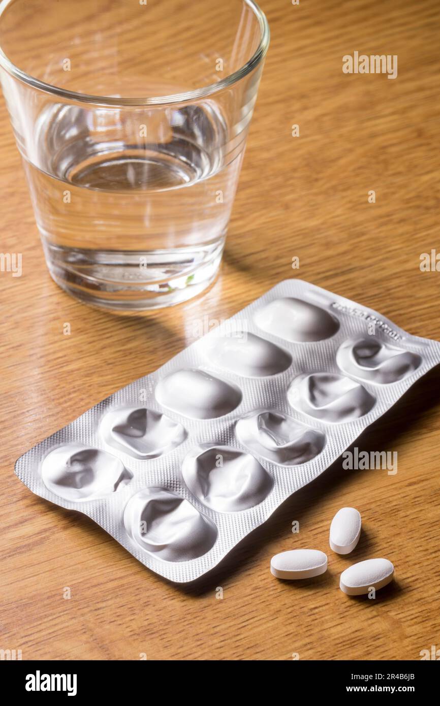 Medicines with a glass of water, tablets, blister pack Stock Photo - Alamy