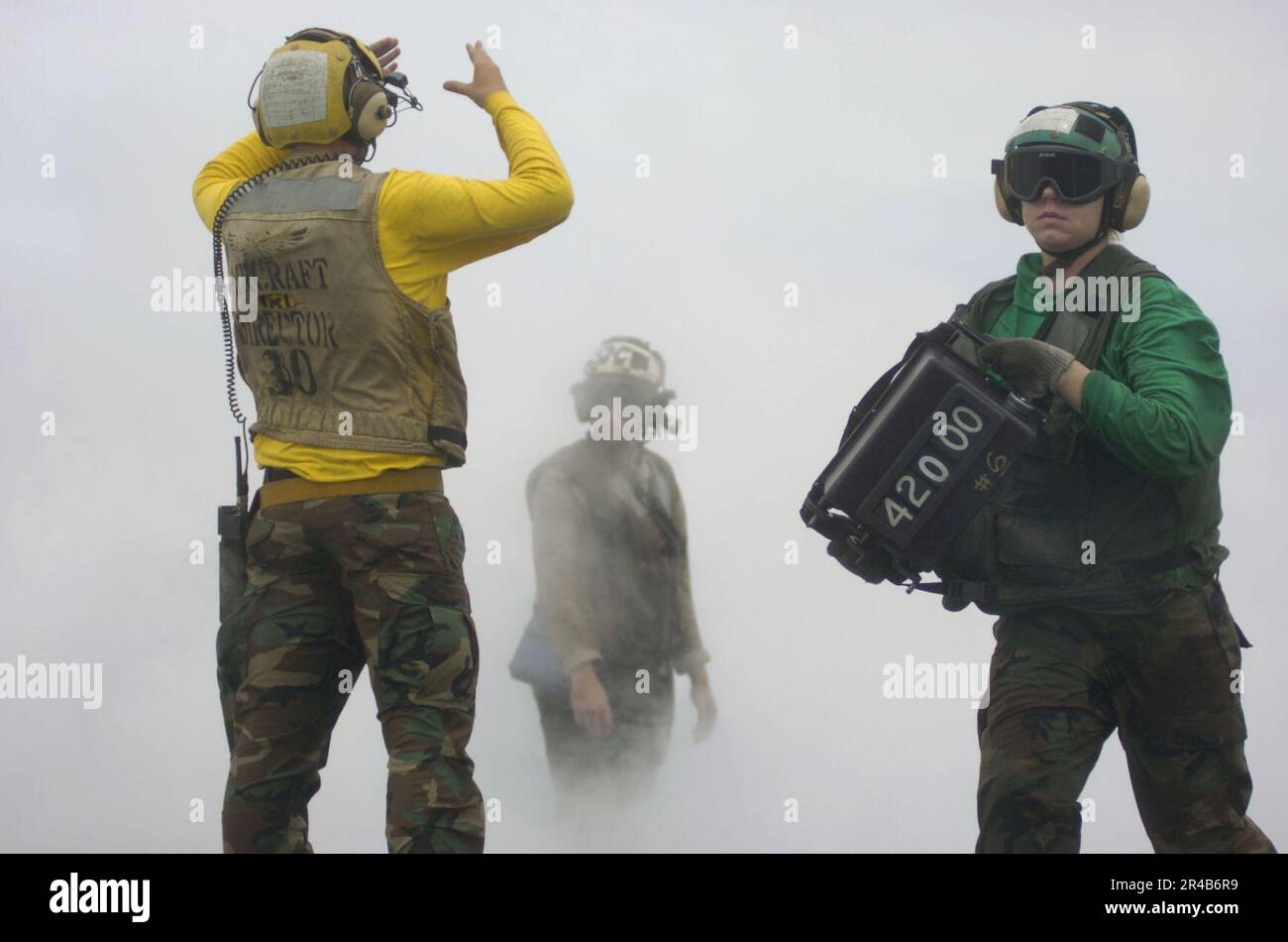 US Navy An aircraft director directs an aircraft to the catapult ...