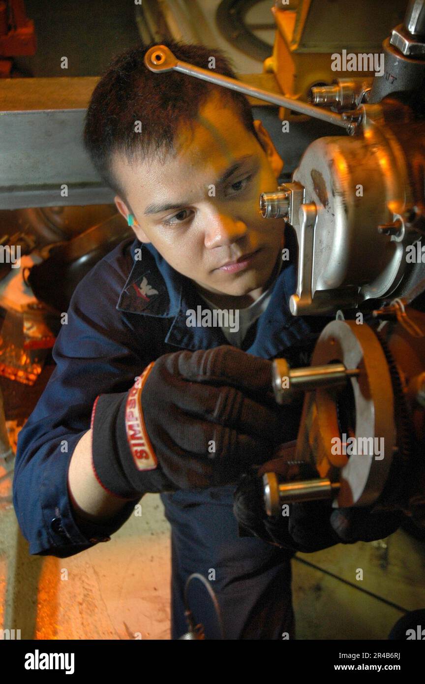 US Navy Aviation Machinist's Mate 3rd Class reassembles a jet engine in ...
