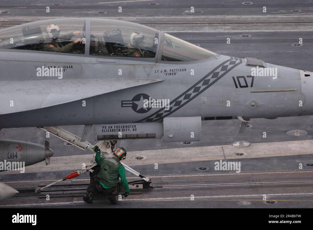 US Navy An Air Department Sailor connects the launch bar of an F-A-18F ...