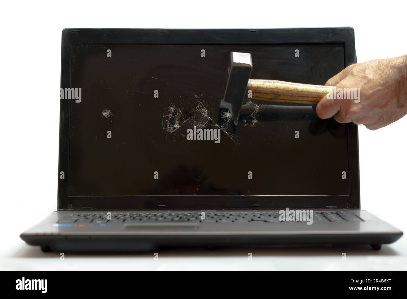 Arm of a man breaking a laptop with a hammer isolated on white ...