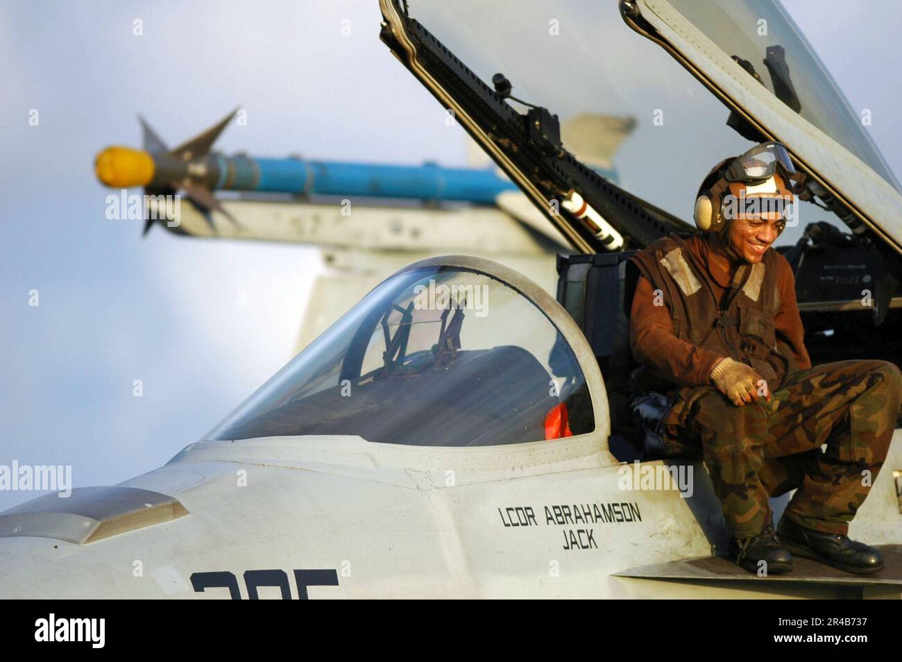 US Navy A plane captain smiles prior to the start of the next launch ...