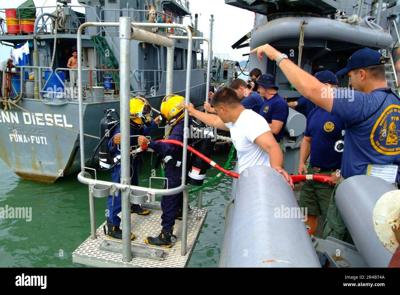 US Navy A pair of Royal Brunei Navy (RBN) divers are lowered from the ...