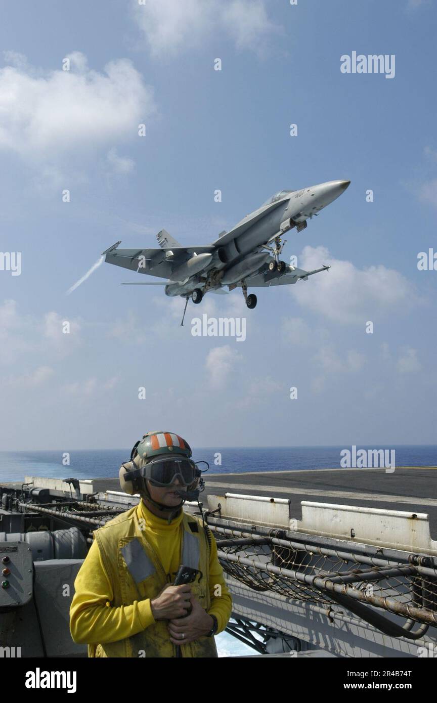 US Navy Lt. observes the foul lines to ensure the safety of flight deck ...