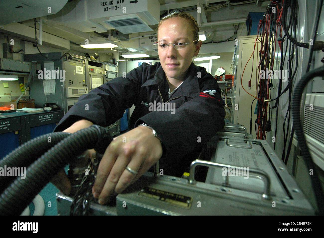 US Navy Aviation Electrician's Mate 2nd Class troubleshoots a component ...