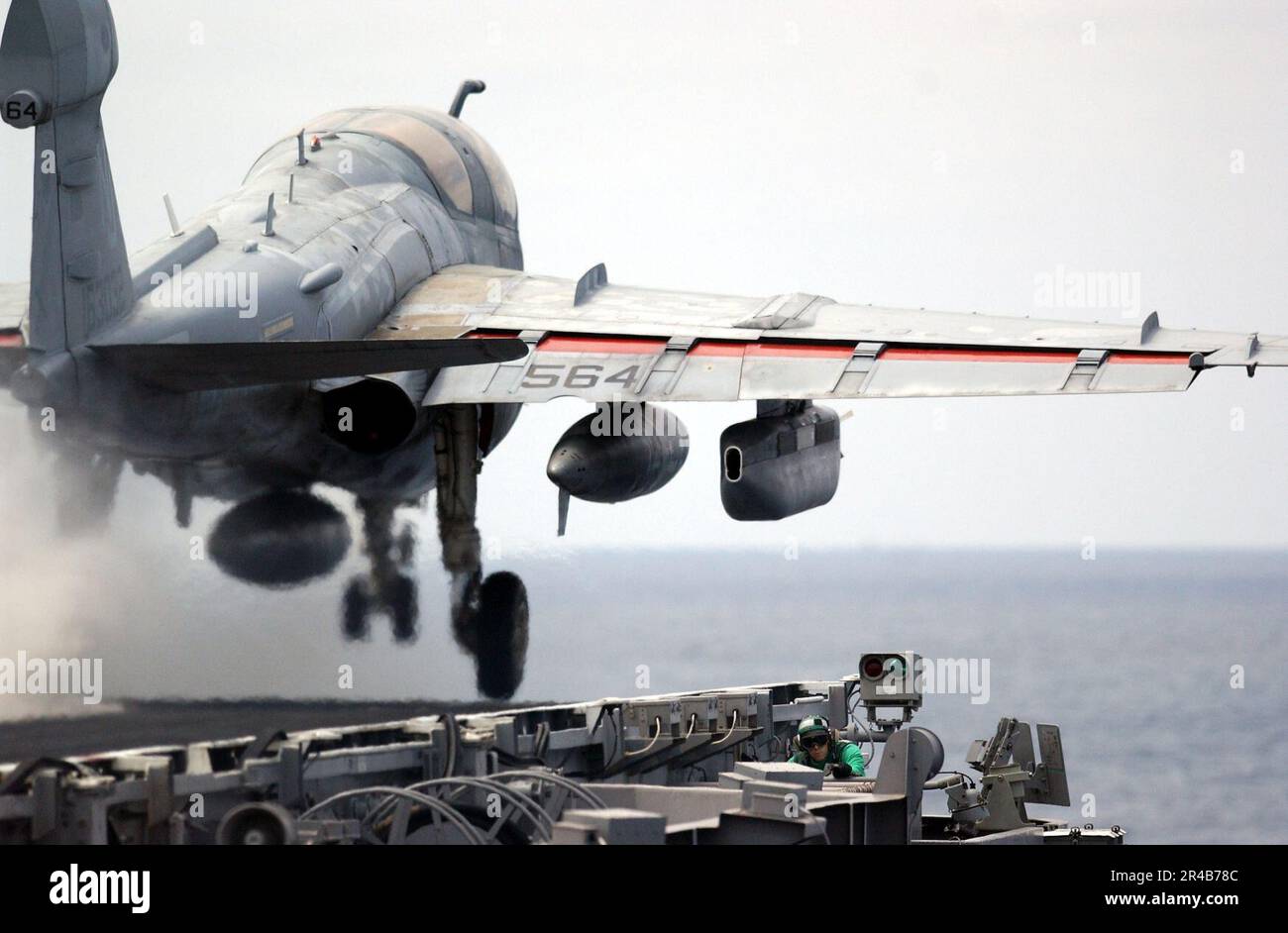 US Navy Airman the Catapult One Bow Safety Observer, ducks down as a EA ...