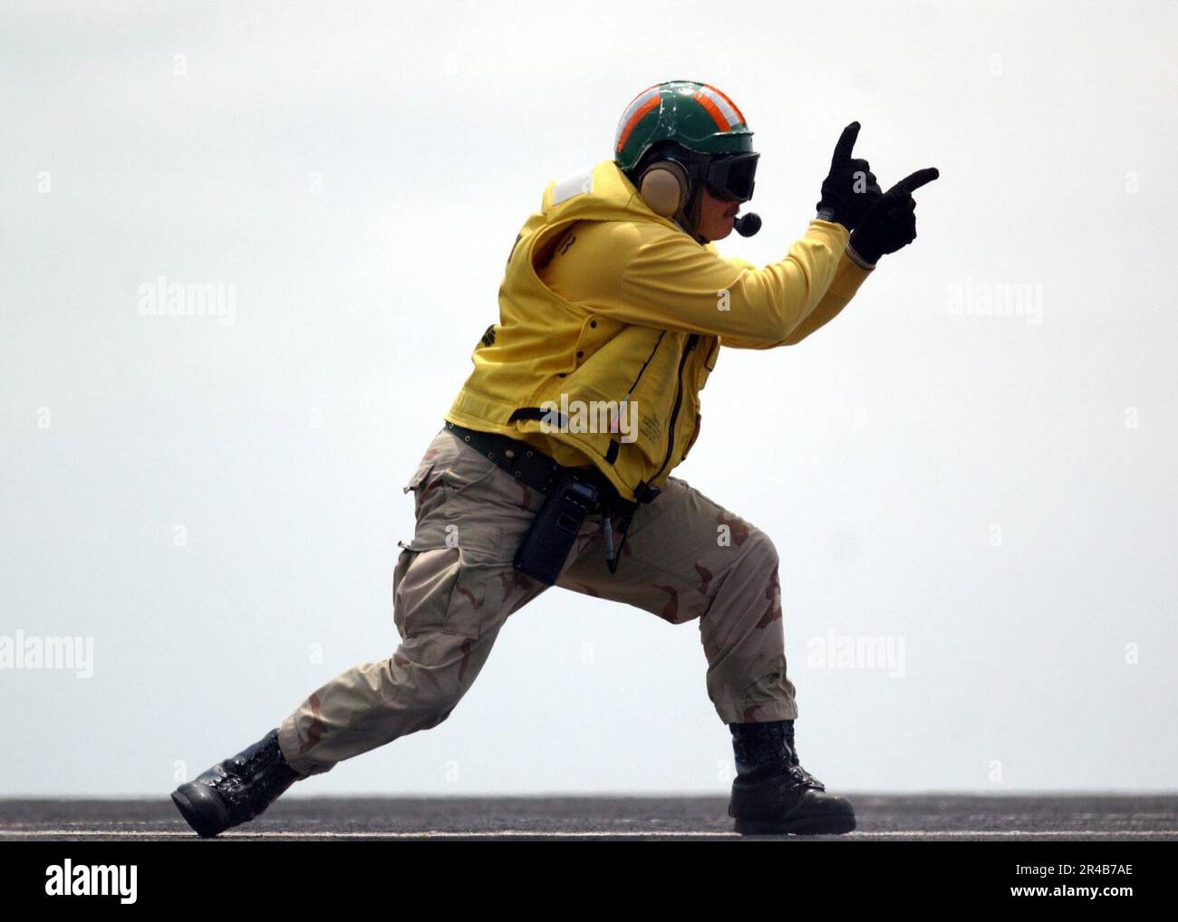 US Navy Catapult shooter, Lt. gives the launch signal to an aircraft as ...