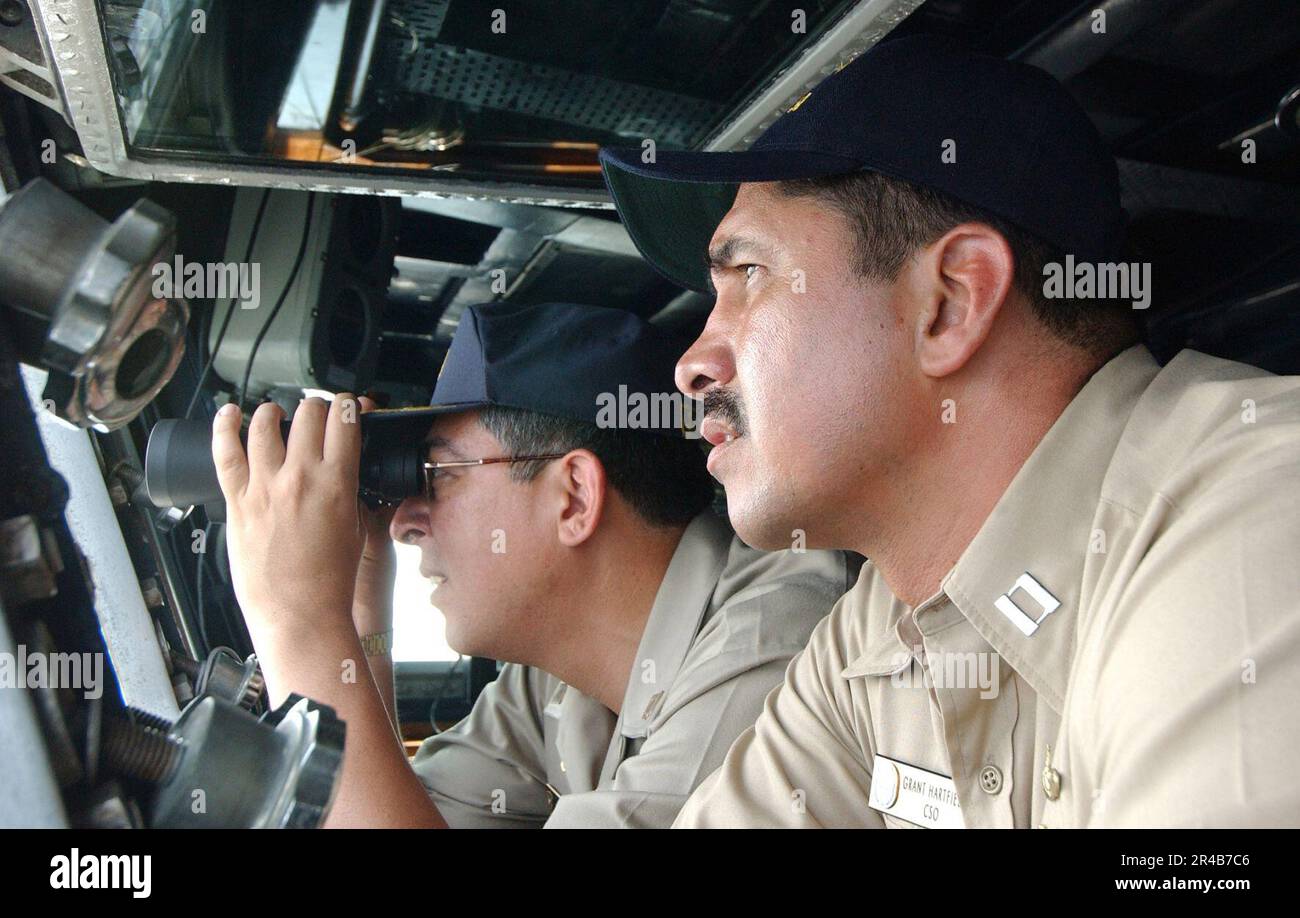 US Navy U.S. Navy Lt. foreground, looks for vessels of interest with ...