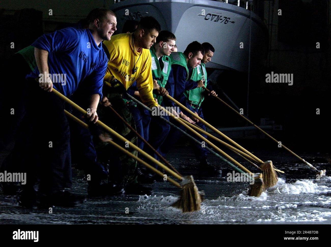 US Navy Sailors conduct a hangar bay scrub down aboard the Nimitz-class ...