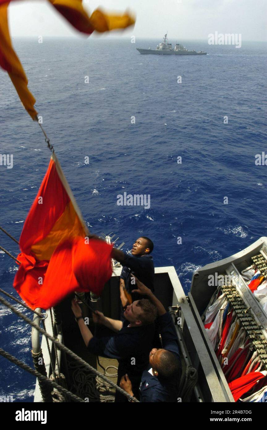 US Navy Sailors assigned to the Navigation Department hoist flags to ...