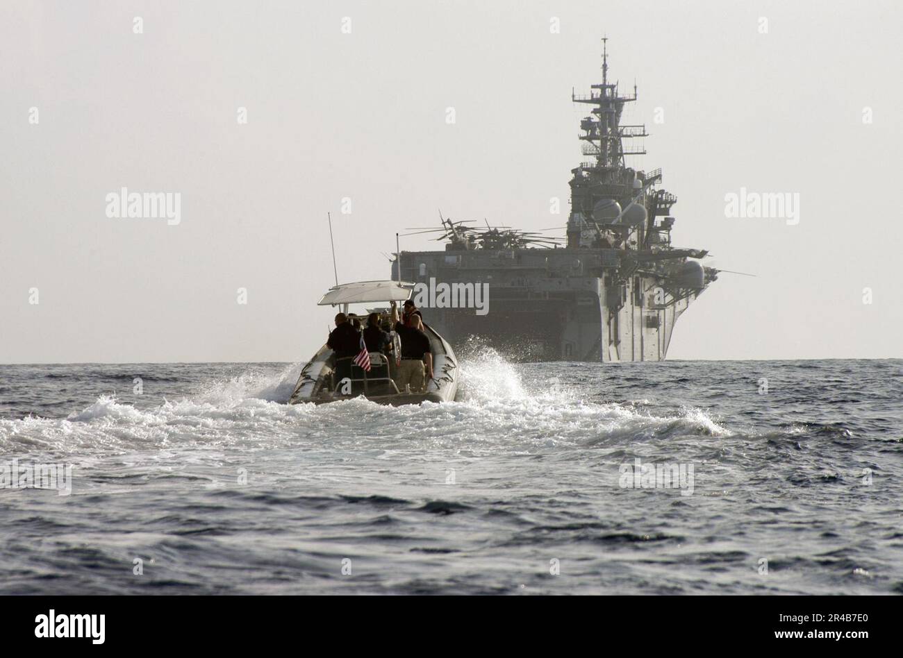 US Navy A Rigid Hull Inflatable Boat (RHIB) trails the amphibious ...