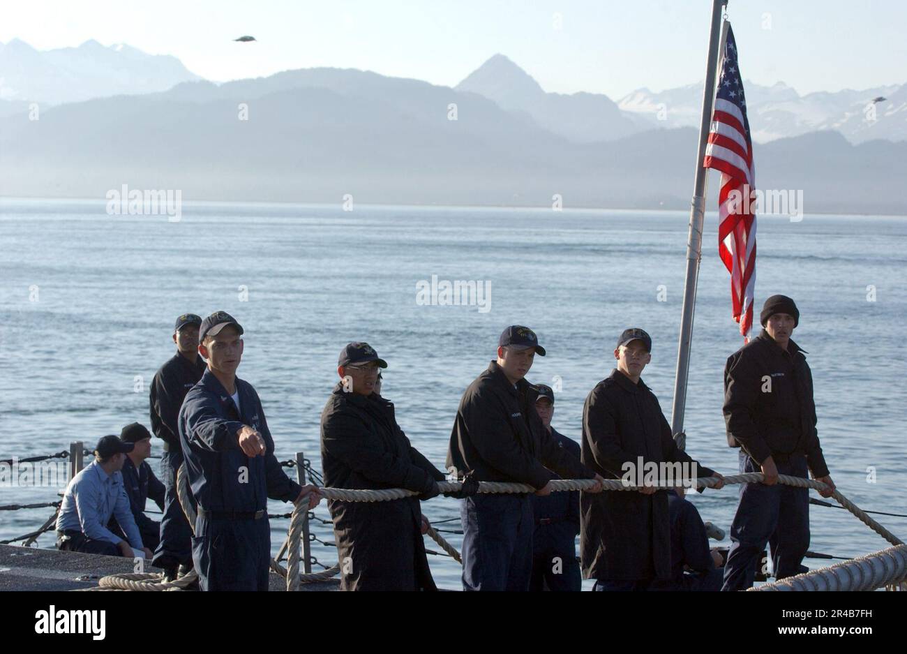 US Navy Linehandlers stationed aboard the guided missile frigate USS ...