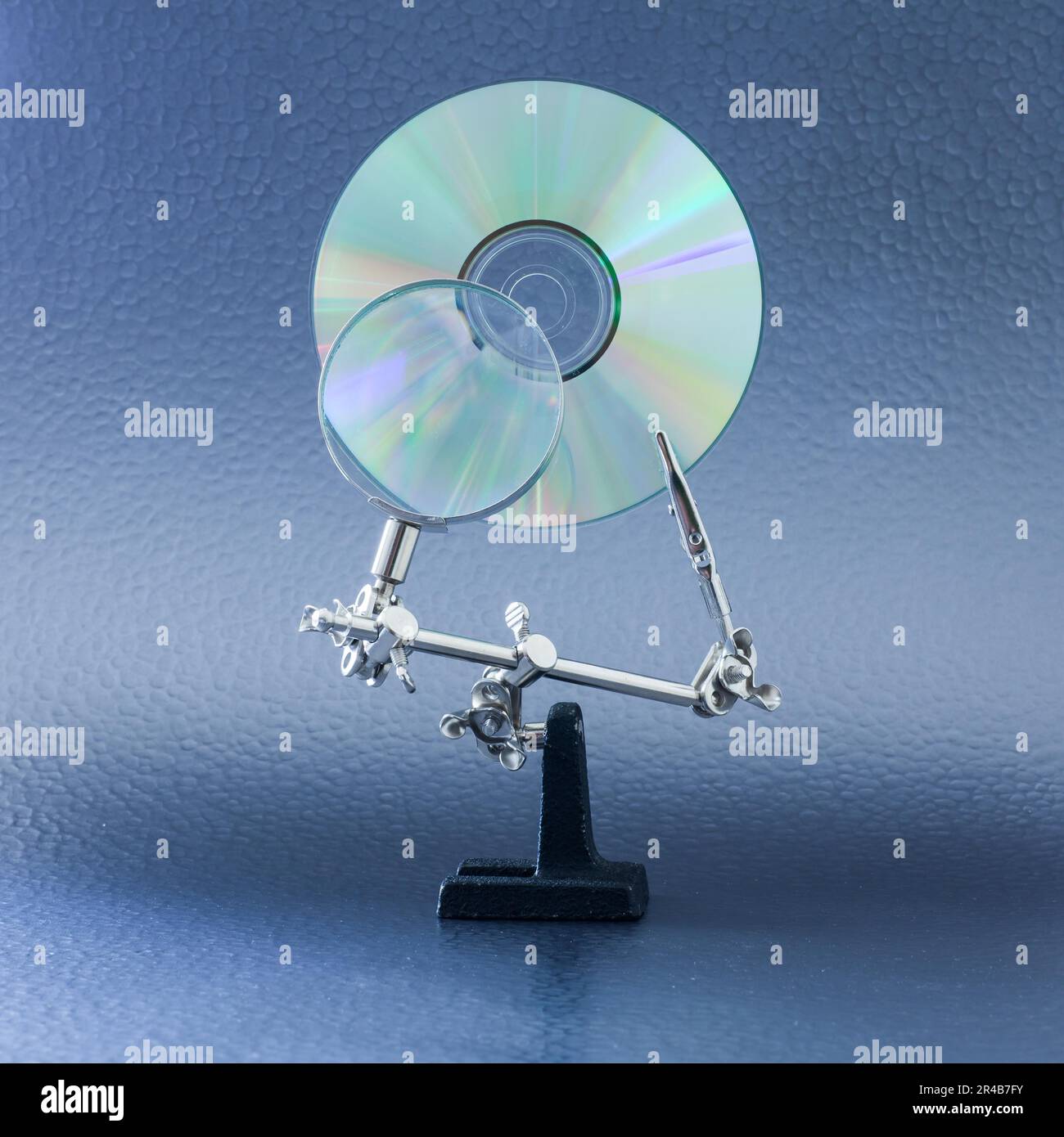 Concept for data analysis, CD and lens on a vivid colors background ...