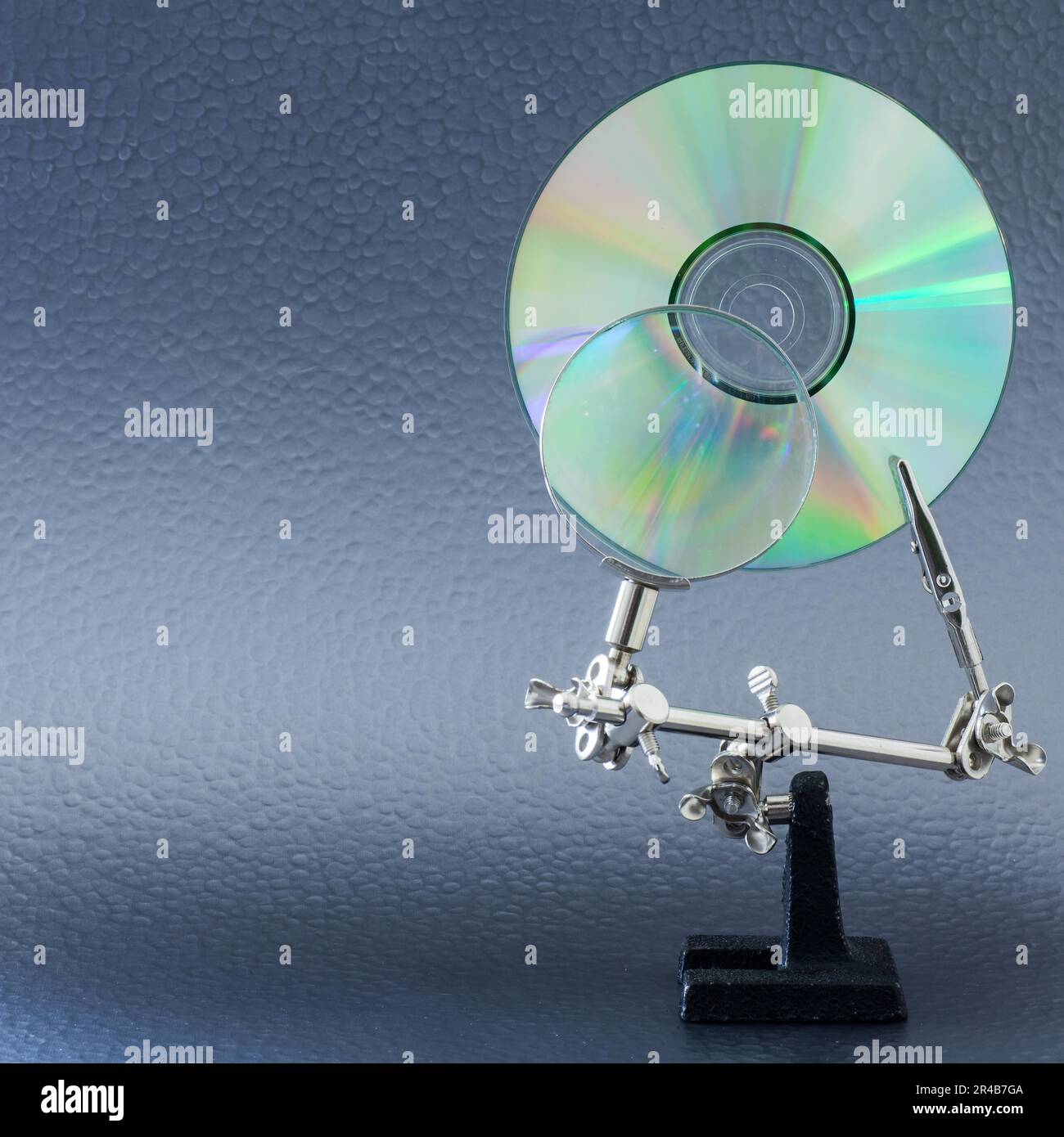 Concept for data analysis, CD and lens on a vivid colors background ...